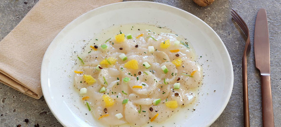 Scallops carpaccio with walnut oil, Sarawak pepper and citrus